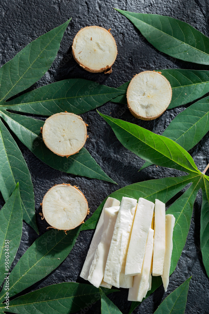 pile of cassava fruit and cassava flour on a background of rustic and ...
