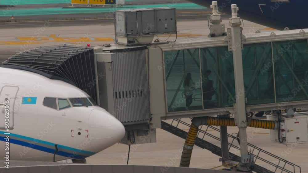 Airplane arriving at Phuket airport. Passengers get off the plane on a ...