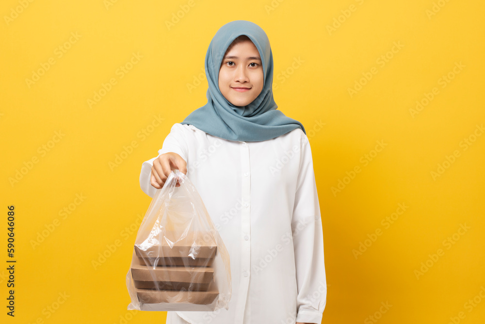 Young asian muslim woman giving food box for iftar ramadan isolated ...