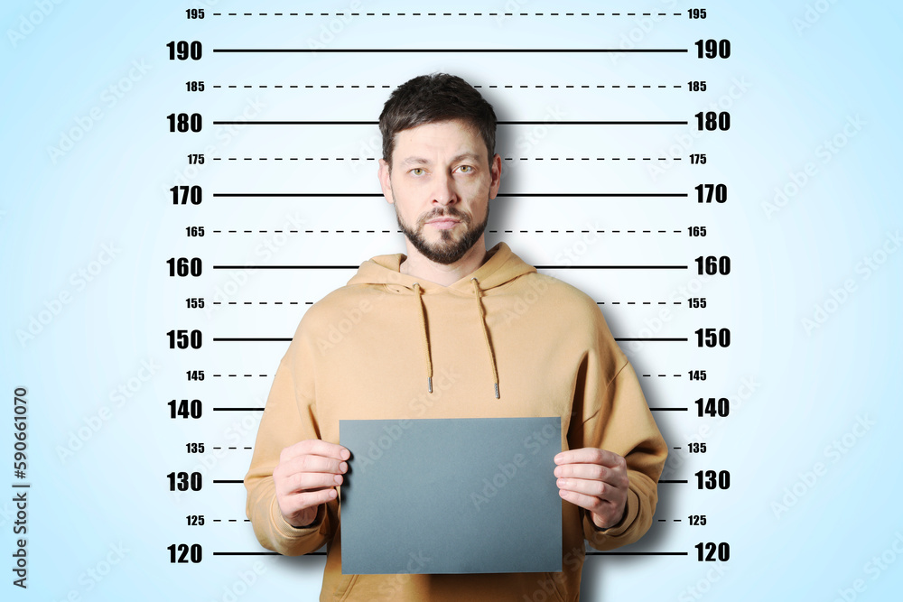 Criminal mugshot. Arrested man with blank card against height chart ...