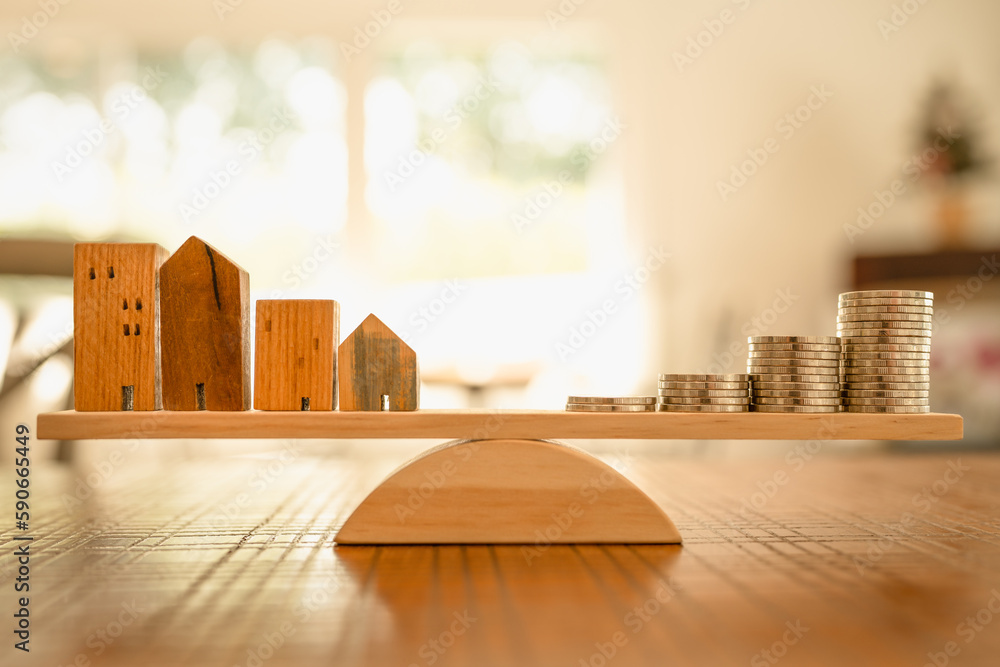 Foto de Wood house and Coins stack with balance scale. Money management ...