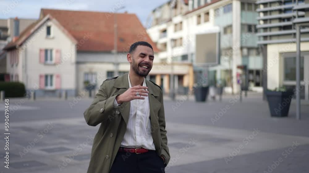 Stockvideon One happy Middle Eastern man smiling and laughing while ...