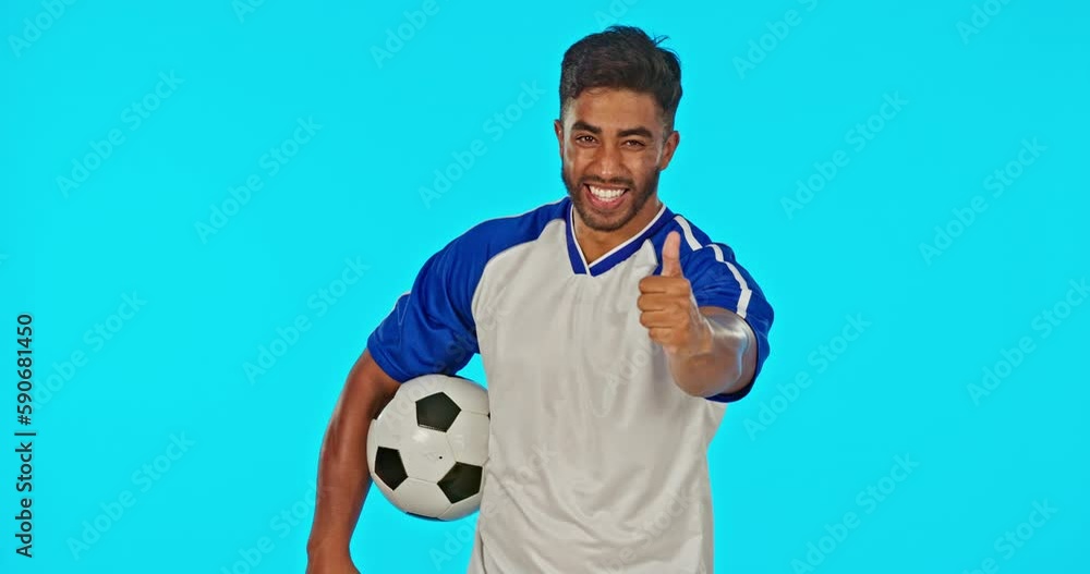 Soccer ball, man smile and thumbs up in studio isolated on a blue ...