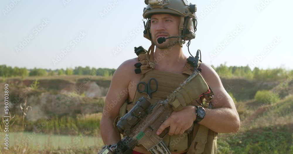 Armed brutal muscular shirtless man in a military uniform holding gun ...