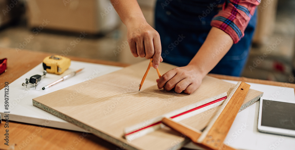 A Carpenter carefully measures, marks dimensions, and lays out ...