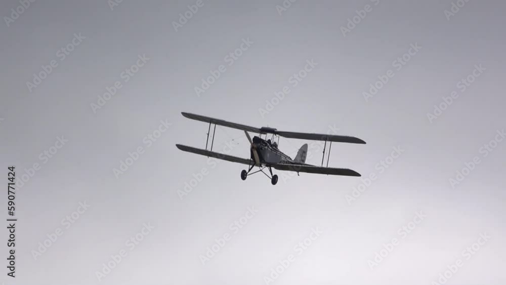 Low-angle shot of the vintage biplane flying in the sky Stock Video ...