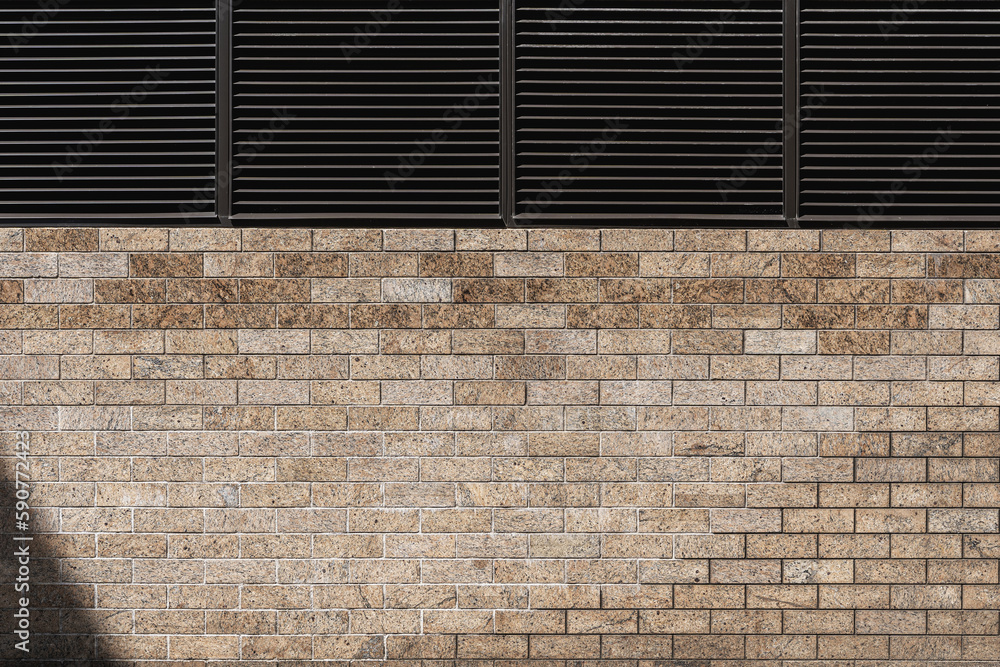 Brick wall with ventilation grilles providing a unique backdrop for ...