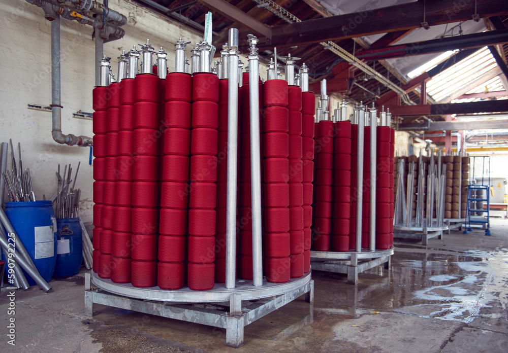 Red spindles of industrial cotton in a weaving factory, machine weaving ...