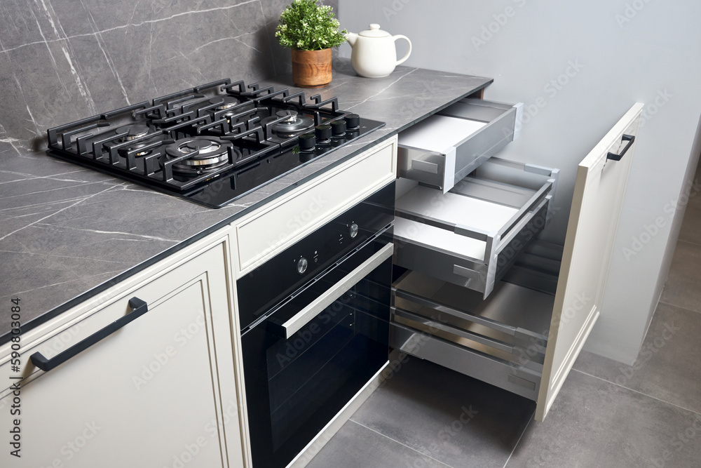 Gas cooker black glass and iron hob on marble light stoneware ...