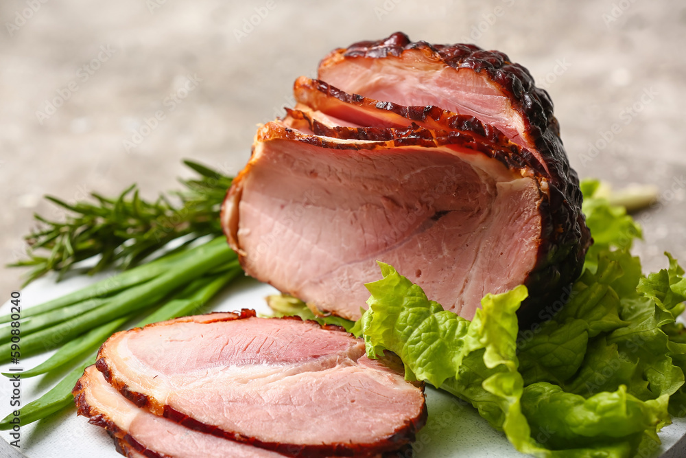 Board with tasty smoked ham and greens on grey background, closeup ...