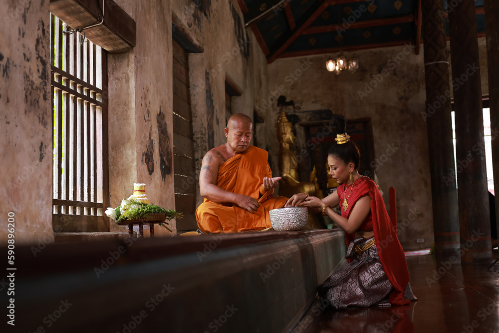 Foto de Asia woman with red Thai traditional dress respect Monk on ...