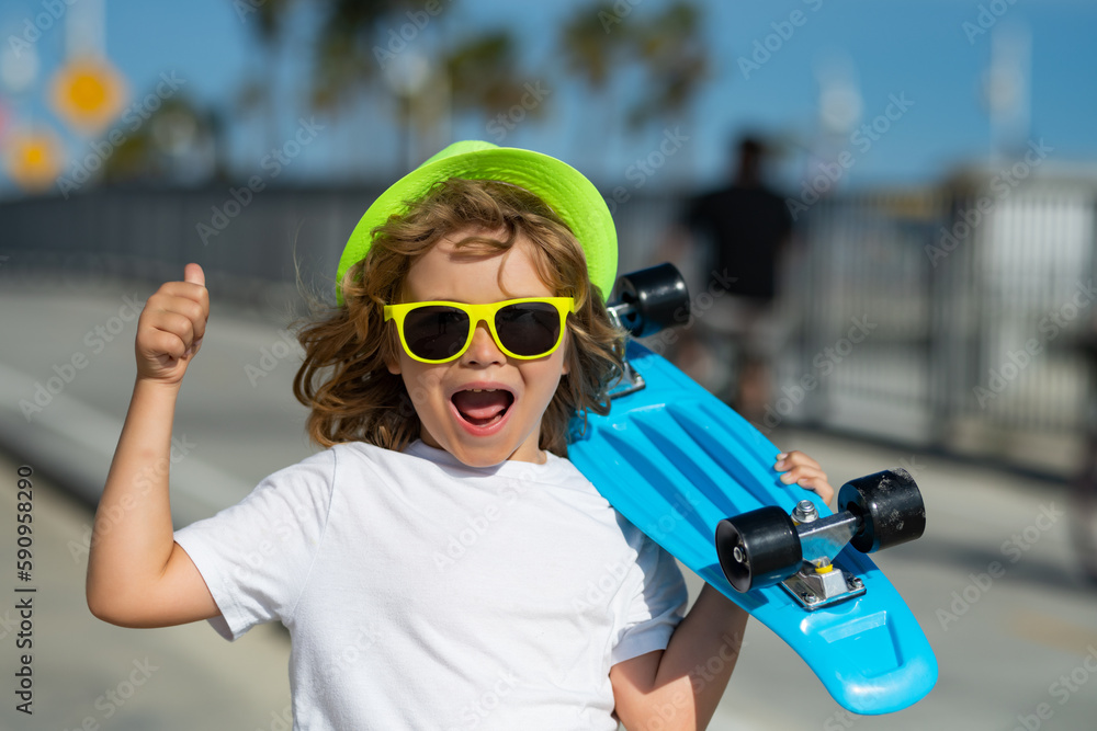 Little kid boy 7-8 years old hold skateboard posing on street outdoor ...