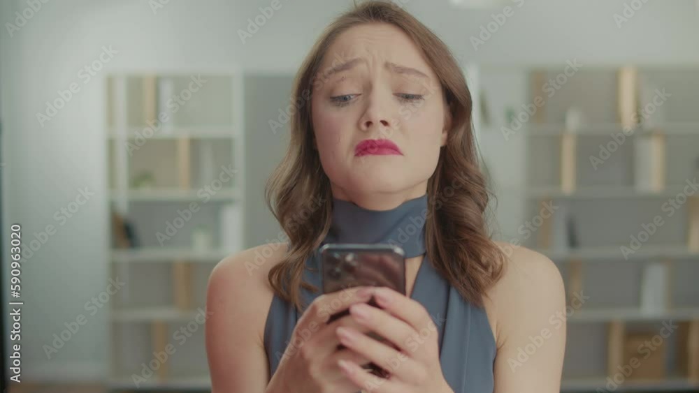 Vidéo Stock A Depressed Young Woman is Crying While Looking at Her ...