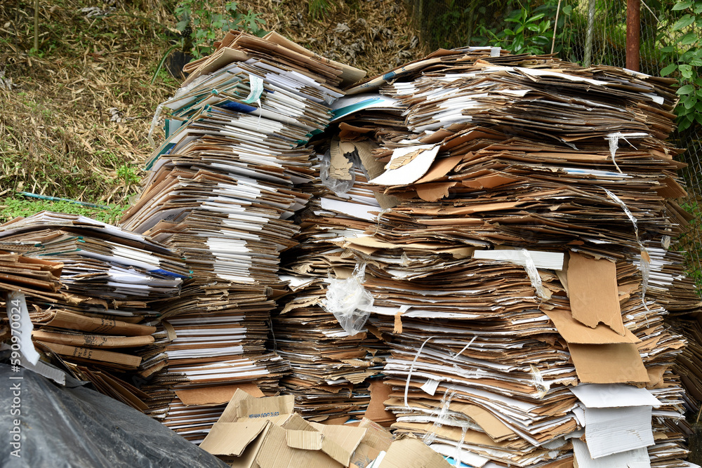 Foto de Compressed cardboard and waste paper collected in piles for ...
