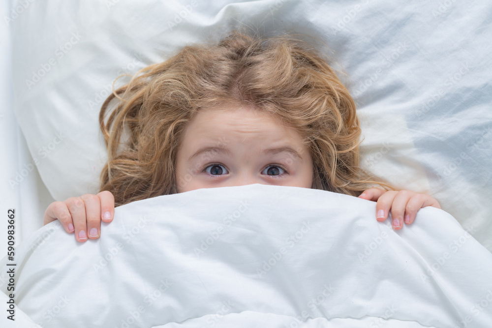 Nightmare kids, child hiding under white blanket, top view. Scared boy ...