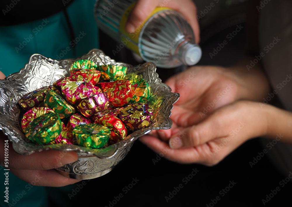 Turkish traditional islamic fiesta culture. Serving chocolat, candies ...