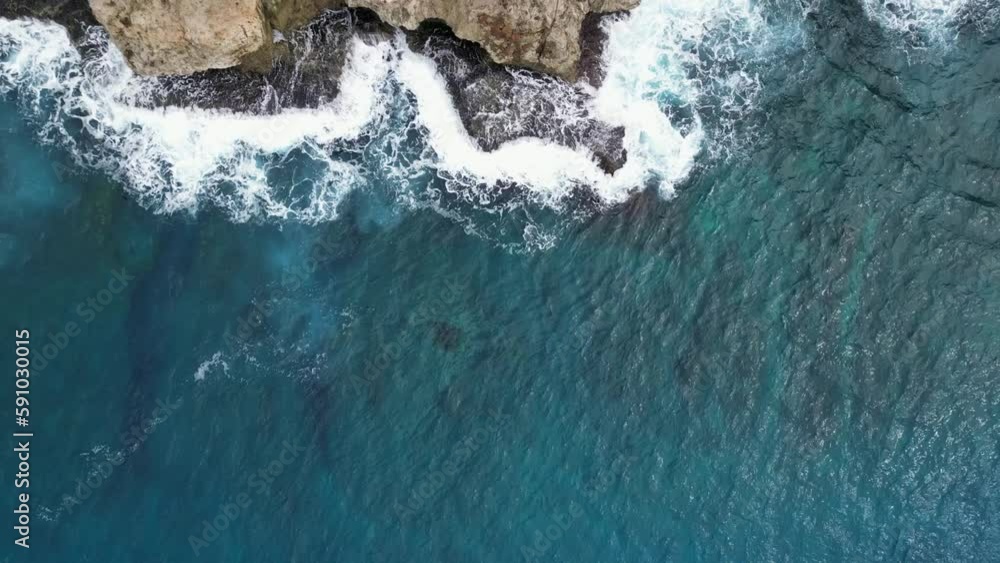 Turquoise Ocean Waves From The Sea Crashing To The Rocks At Oka Point ...