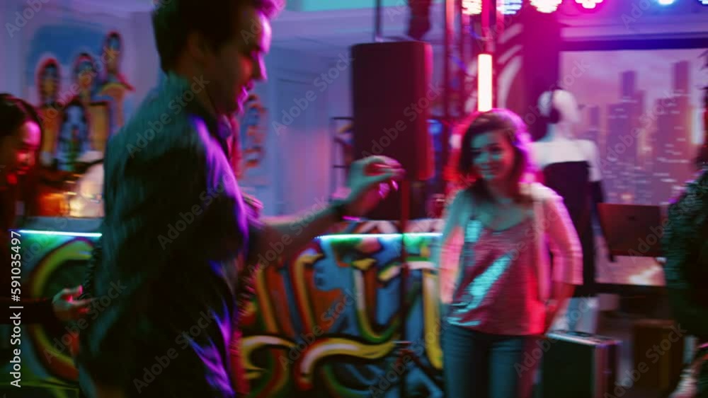 Diverse people having fun at party, dancing and jumping around on dance ...