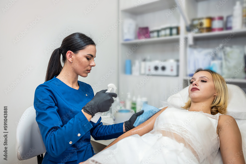 beautician doing epilation procedure for unwanted hair wax epilation in ...