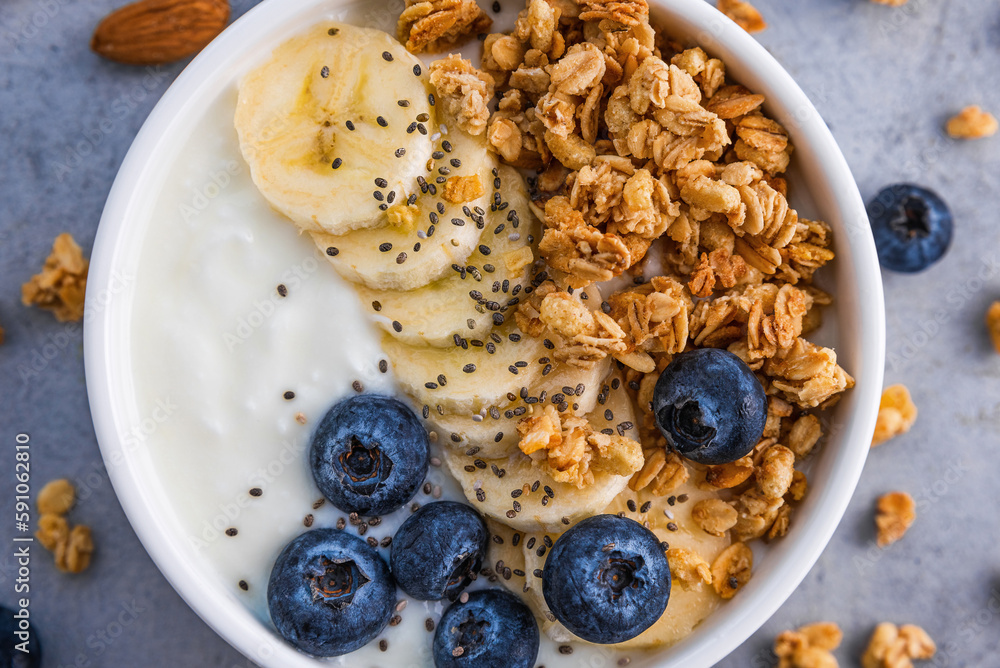 Healthy breakfast. Bowl of greek yogurt with oat granola, fruits, nuts ...
