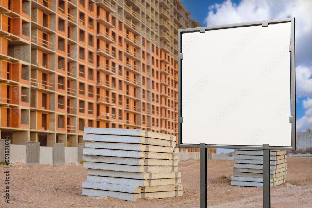 Construction site. Empty signboard near panel house. Construction of ...