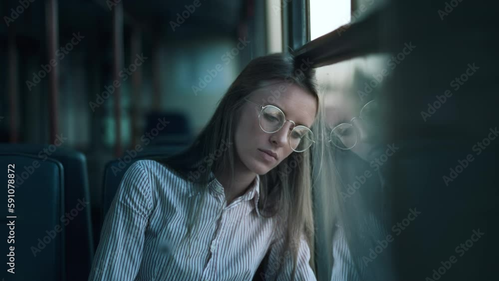 Worried young woman is traveling inside of a bus. Depressed sad female ...