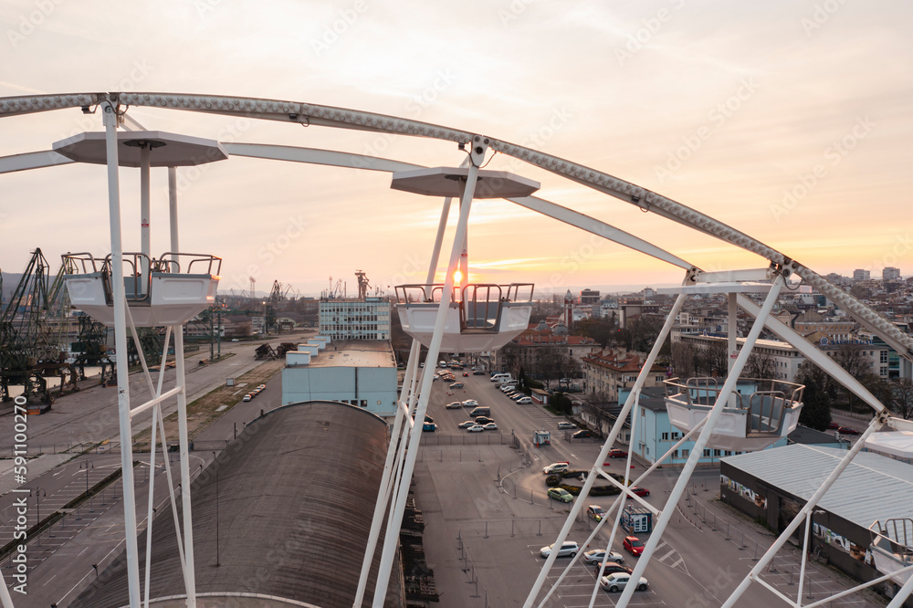 Aerial drone close up shot Ferris wheel booths on the beach at sunset ...