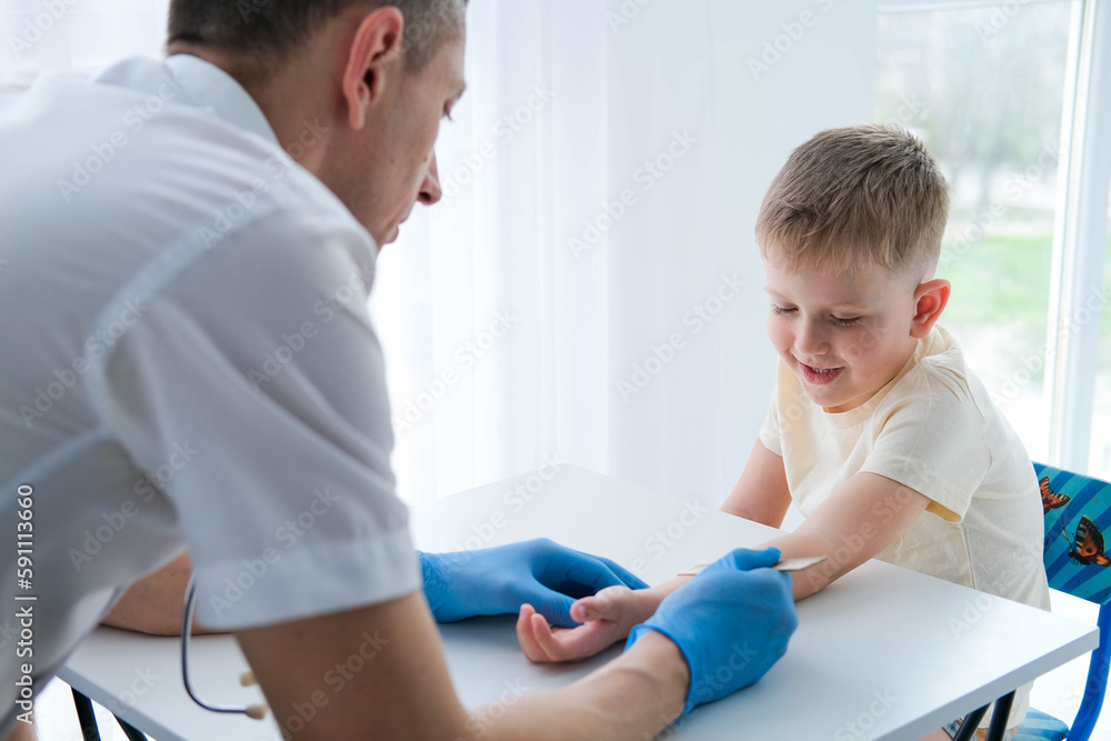 A male doctor makes an important Mantoux test on a child. The doctor ...