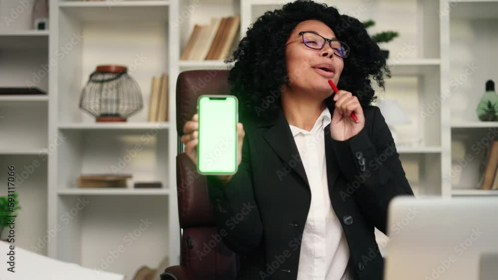 Funny happy african american businesswoman at workplace singing in pen ...