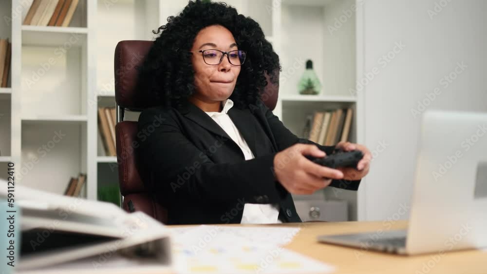 Excited young african american businesswoman gamer sitting at desk on ...