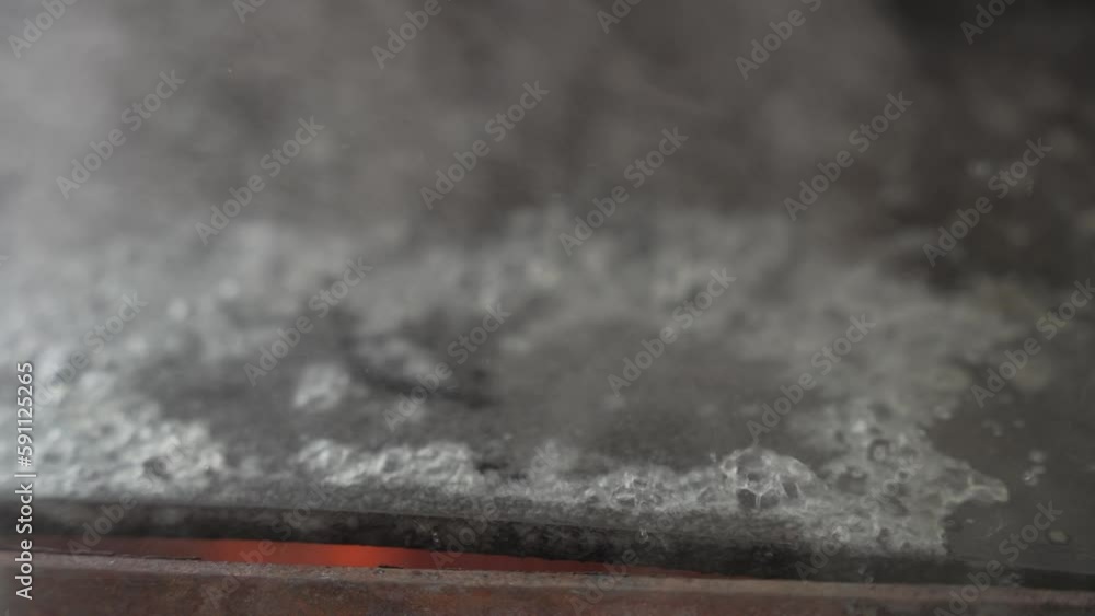 Witness the incredible science of evaporating water on a hot barbecue ...