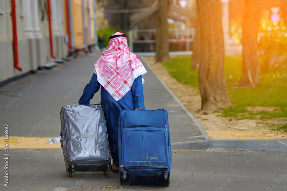 Arab man with baggage travelling. Man with bag and suitcases walking ...