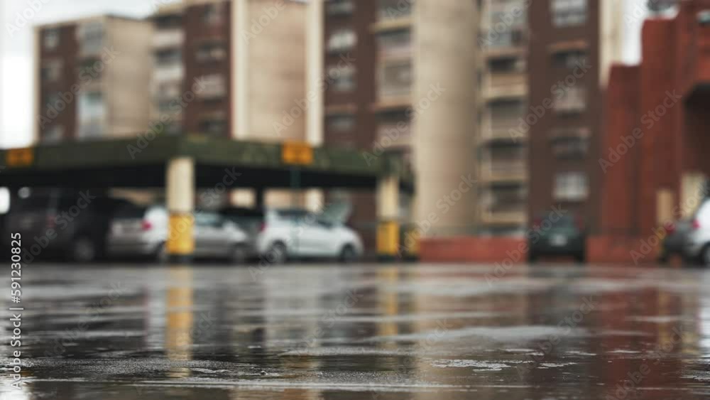 Close-up of rain drops on the pavement of multi-level parking lots ...