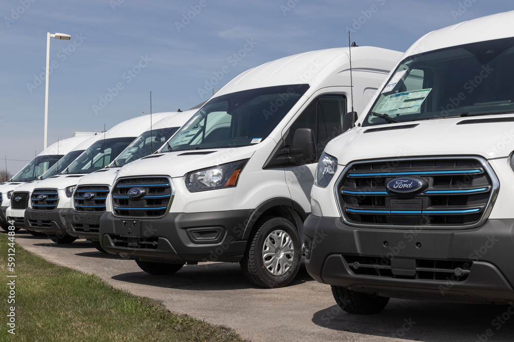 Ford E-Transit Cargo Van display at a dealership. Ford offers the E ...