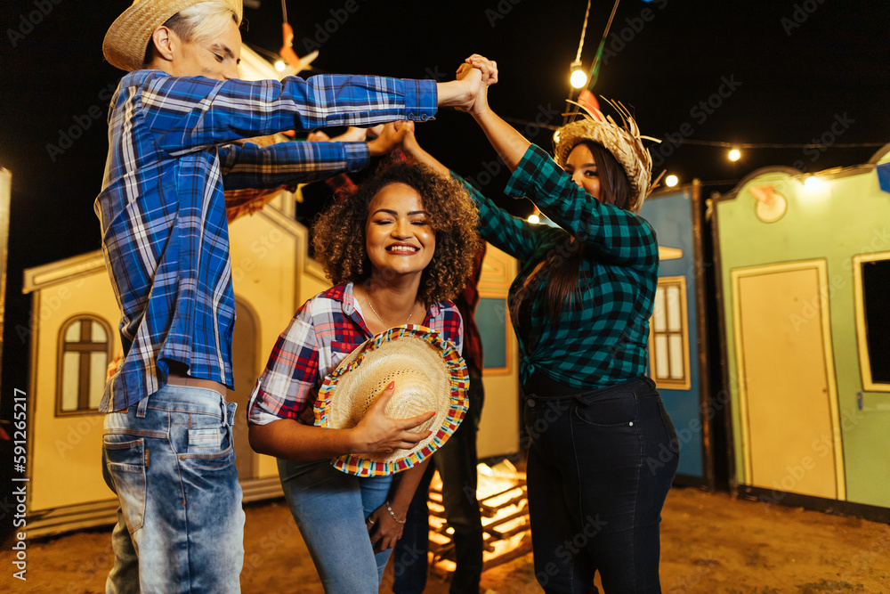 Foto de Festa Junina in Brazil. Group of friends dancing the Brazilian square dance. do Stock ...