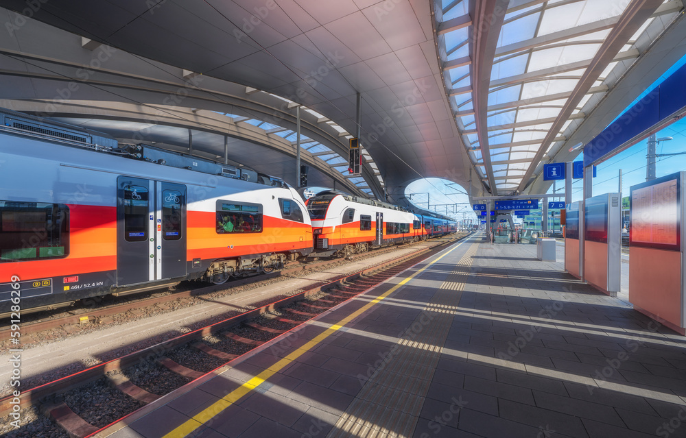 High speed train on the modern railway station at sunset in Graz ...