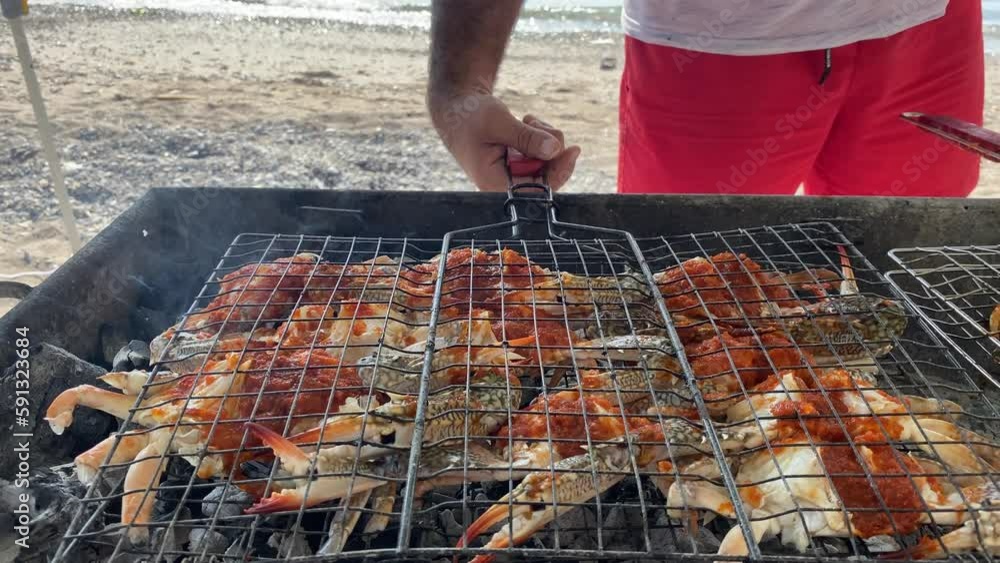 Video Stock Side view arabic chef turns fresh crabs cooked on bbq grill ...