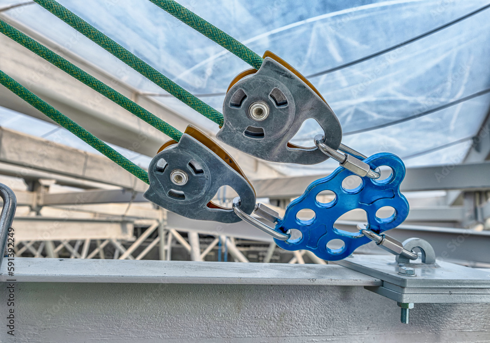 Load lifting system. Blocks rollers on a metal structure Stock Photo ...