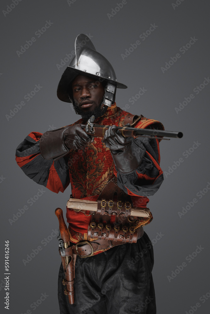Portrait of military man dressed in suit and helmet aiming flintlock ...