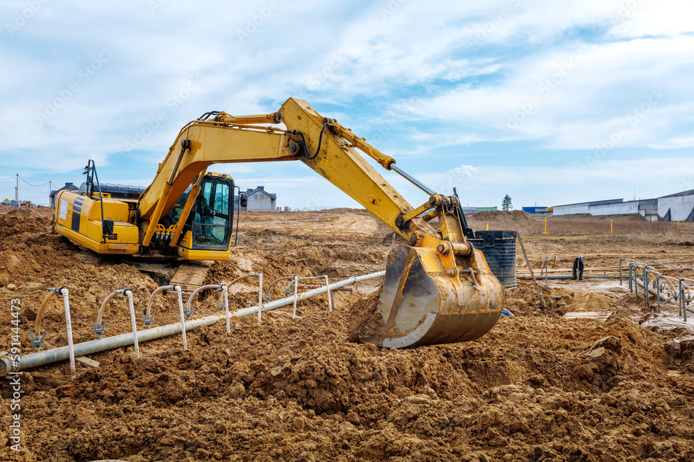 Excavator dig the trenches at a construction site. Trench for laying ...