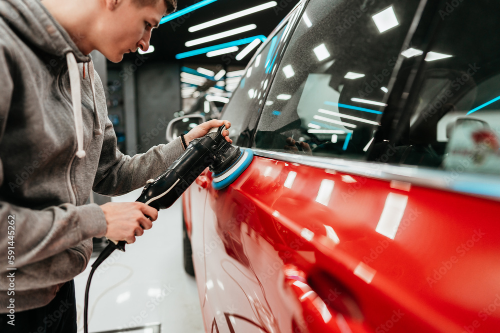 Professional vehicle polishing and detailing service in a modern car ...