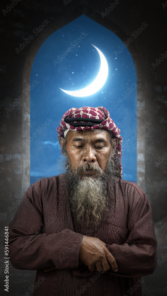 Muslim man with a beard wearing keffiyeh with agal in praying position ...