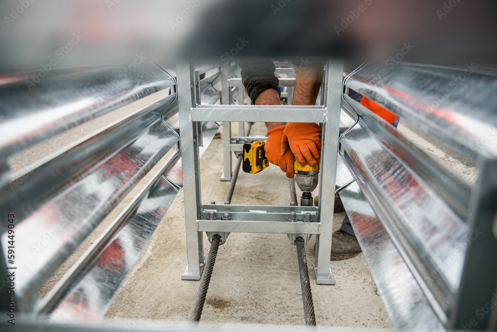 Installation of median crash barriers on highway. Metal road fencing of ...