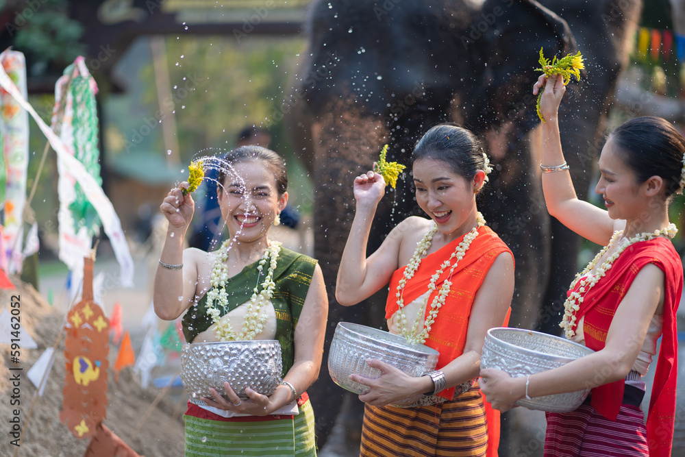 Tourist Asian people wearing traditional Thai dresses are happy to play ...