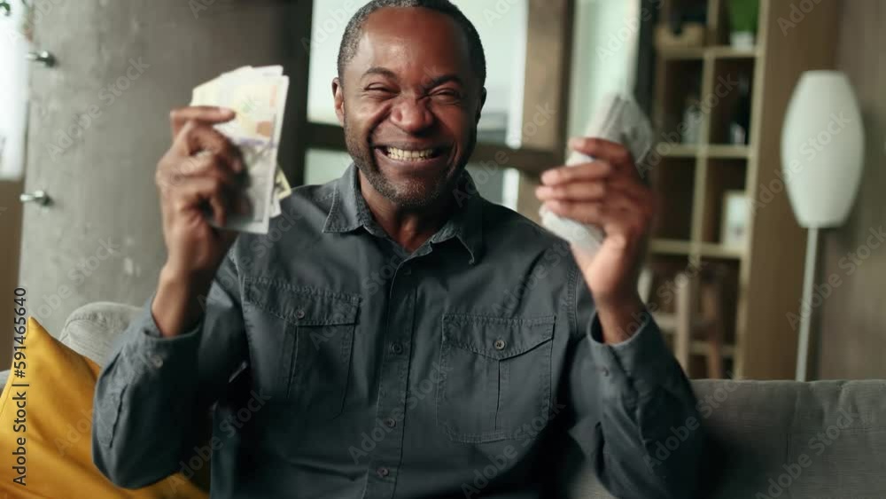 Portrait of mature african american man counting stack of dollars ...