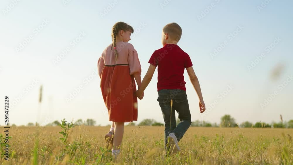 Children walking together in park hand in hand, nature. Happy children ...