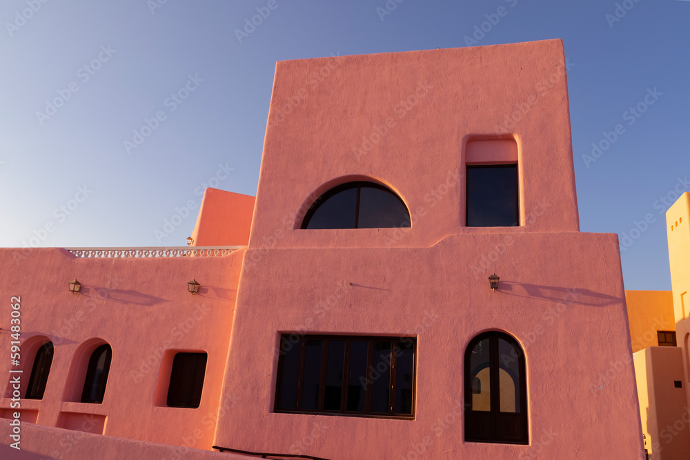 Doha, Qatar - December 12 2022: A pink building in the old port of Doha ...