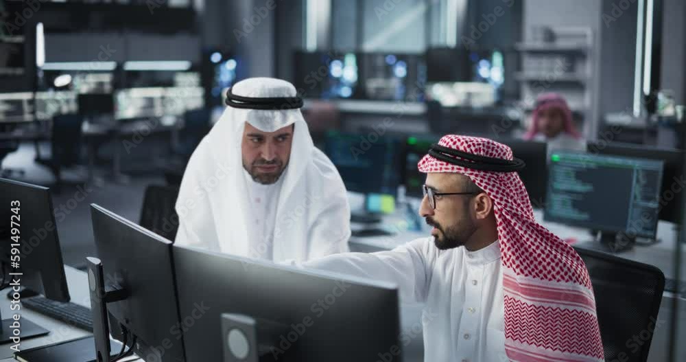 Two Young Saudi Software Engineers Use Desktop Computer to Discuss a ...