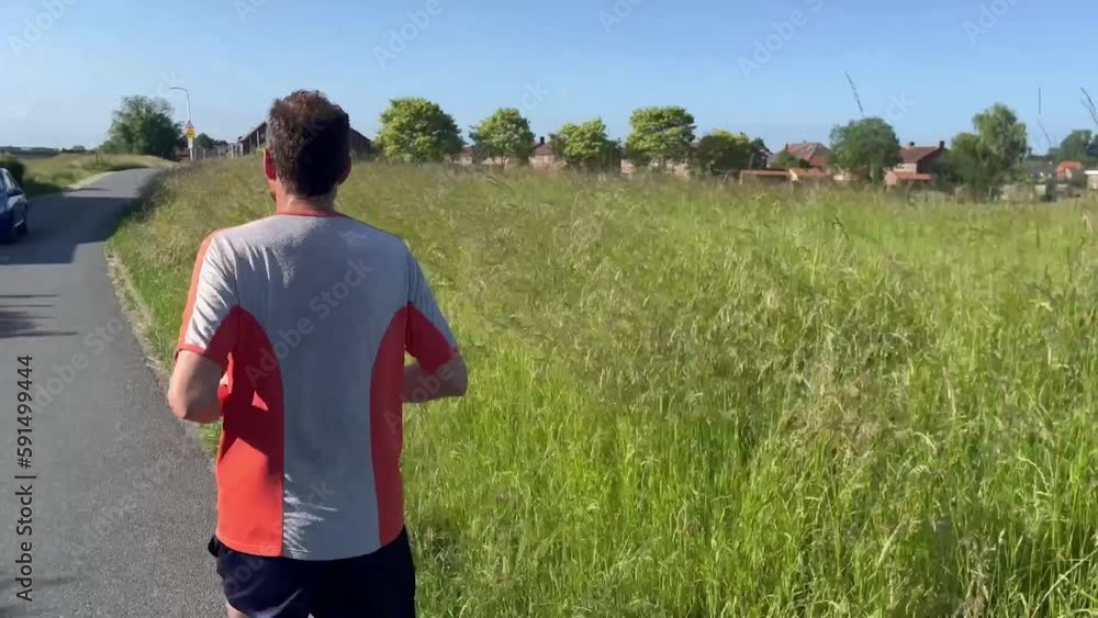 Bright sunny day profile closeup upper body and sweaty face of a male ...