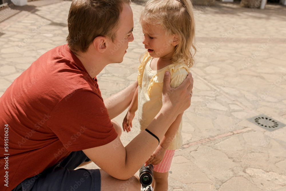 Father consoling crying daughter at footpath Stock Photo | Adobe Stock